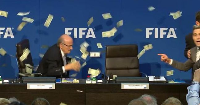 Comedian interrupts FIFA press conference by throwing money at Sepp ...