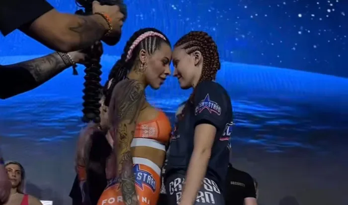 MMA fighters surprise crowd by kissing at face-off and flashing their ...