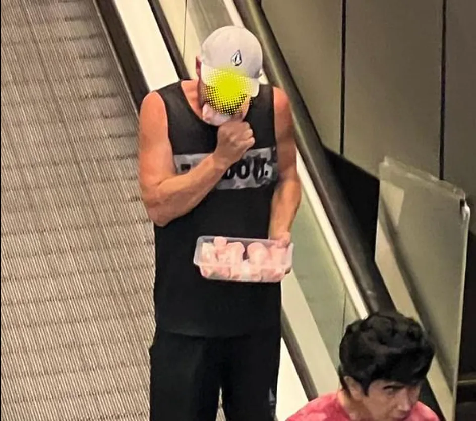 Bloke caught eating raw chicken straight from the packet